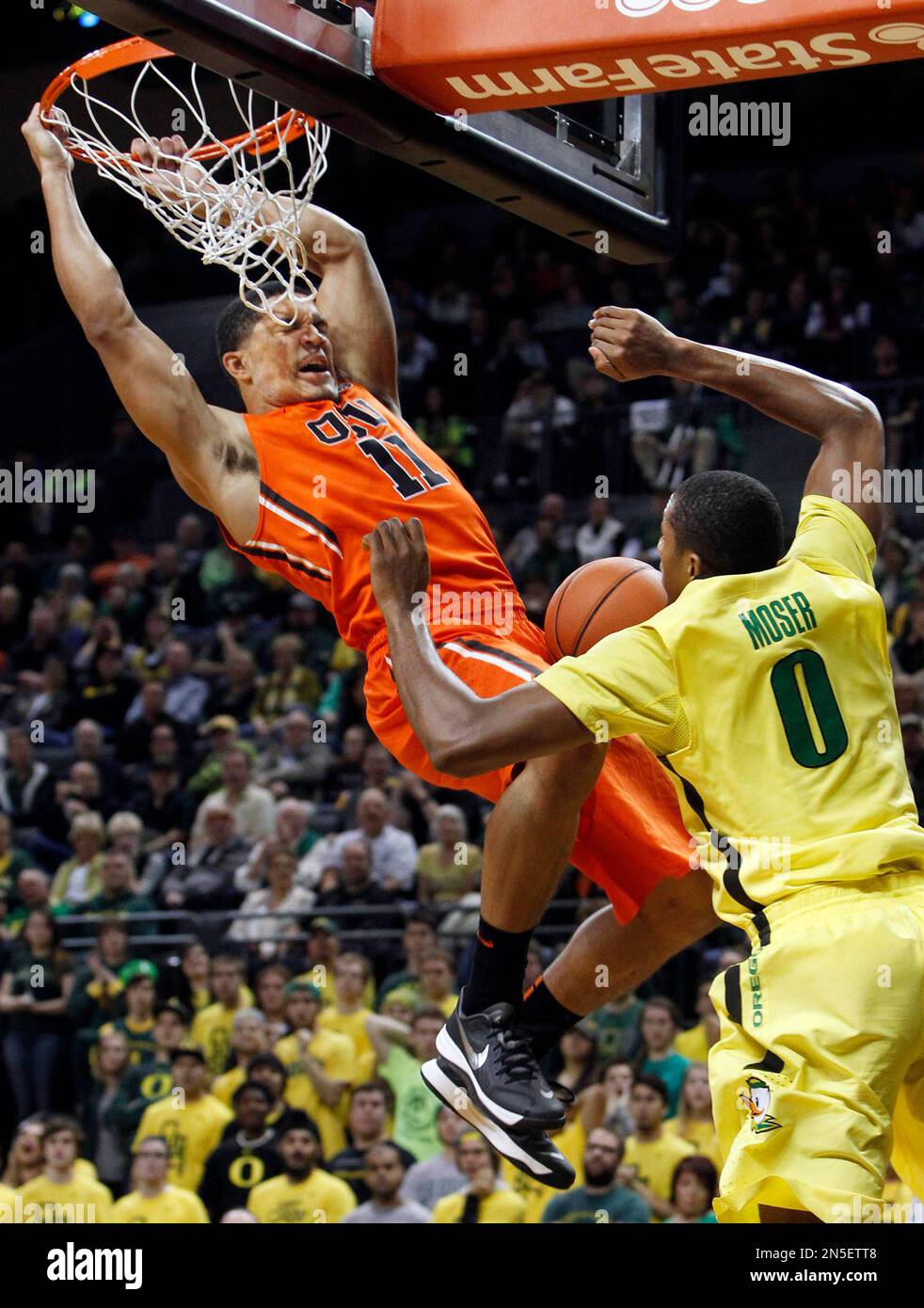 Oregon State's Malcolm Duvivier, left, slams a dunk over Oregon's Mike ...