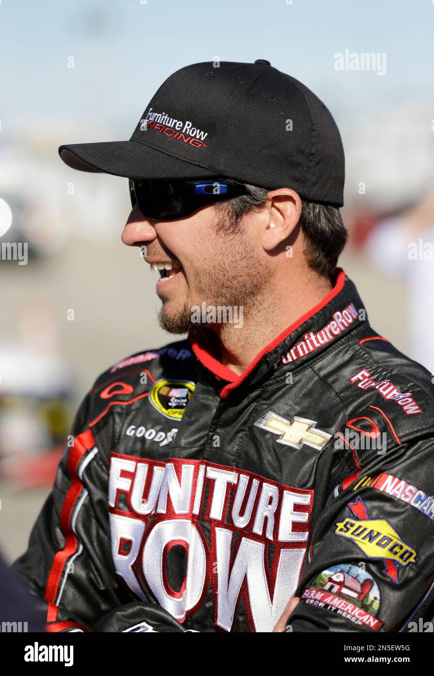Martin Truex Jr. laughs with crew members after he qualified for the No ...