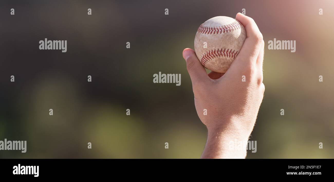 Male hand holding baseball ball on a background stadium Stock Photo - Alamy