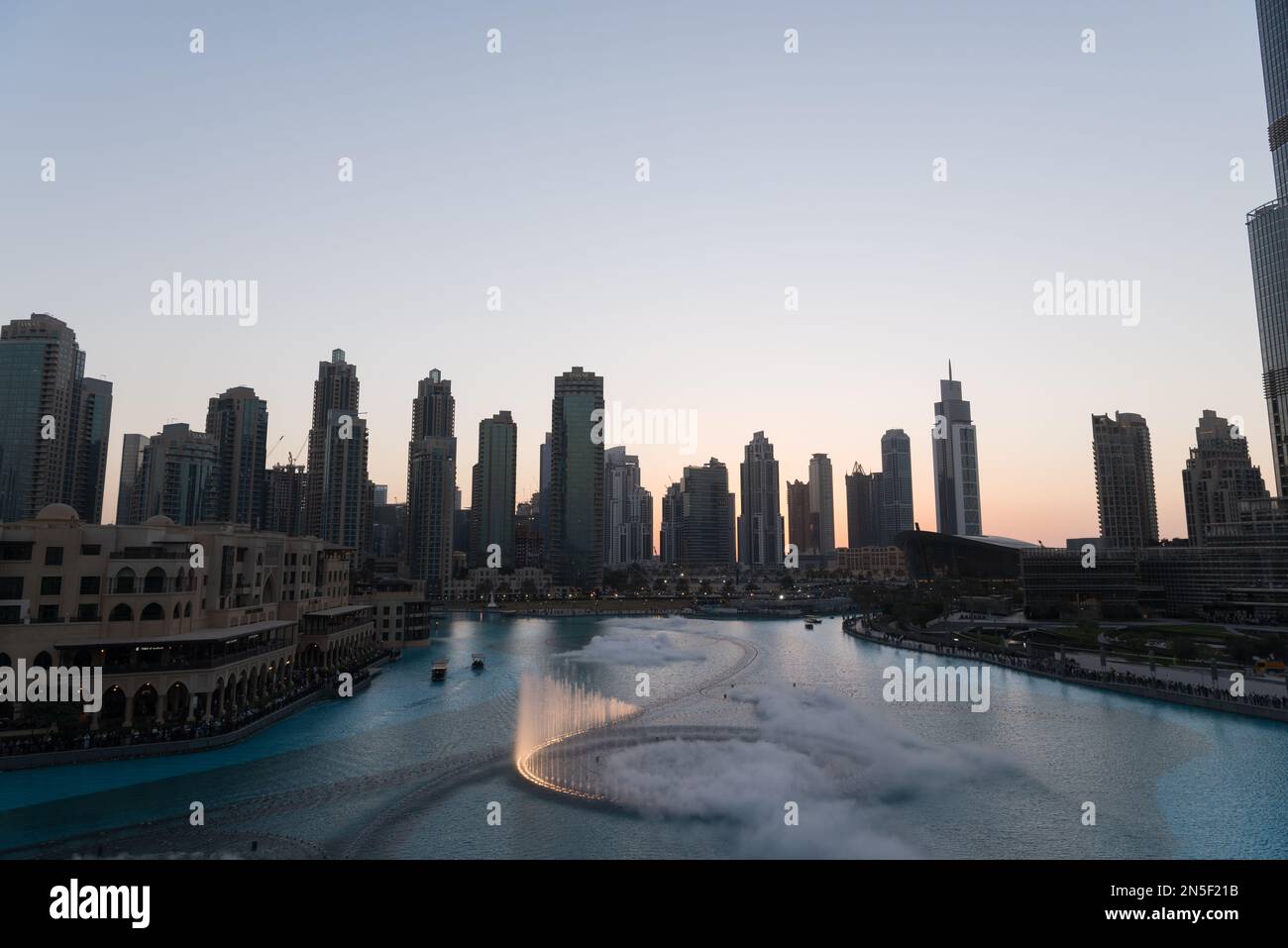 Dubai singing fountains at night lake view between skyscrapers. City ...