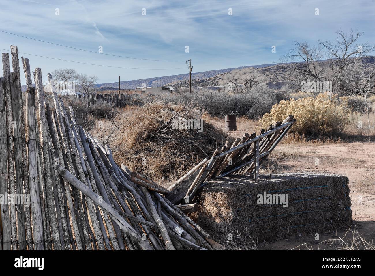 Crumbling wooden pole fence in front of desert vista landscape on a ...