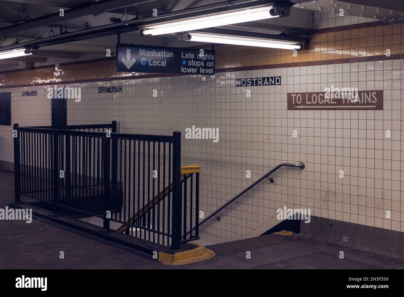 Urban subway station with tiled walls and grungy stairwell in New York ...