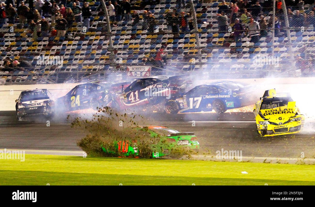Danica Patrick, front center, slides through the infield as Tony ...