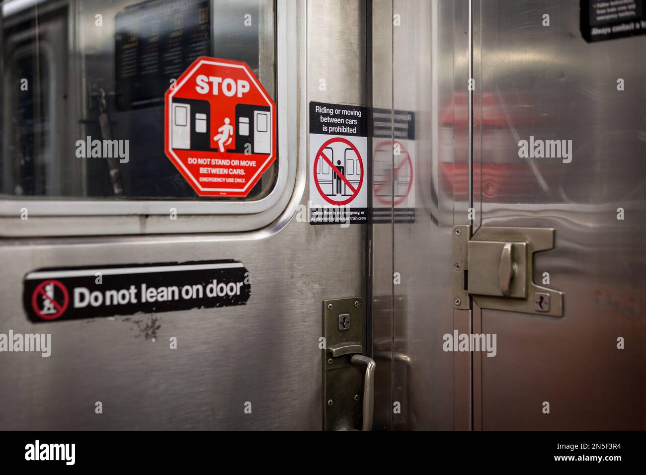 Stickers on subway door of moving train in downtown Manhattan Stock ...