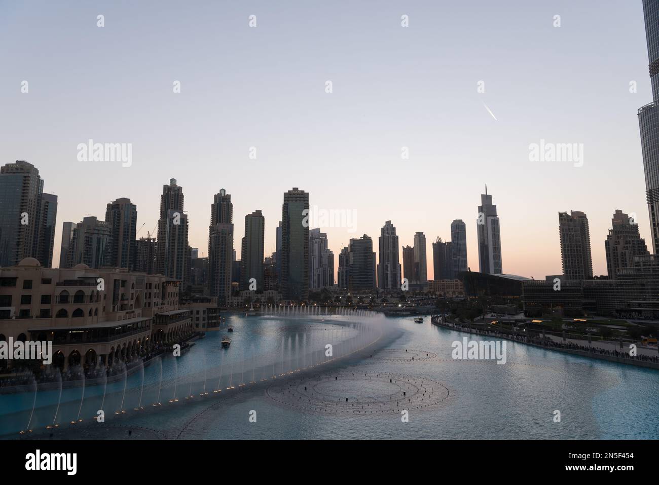 Dubai singing fountains at night lake view between skyscrapers. City ...