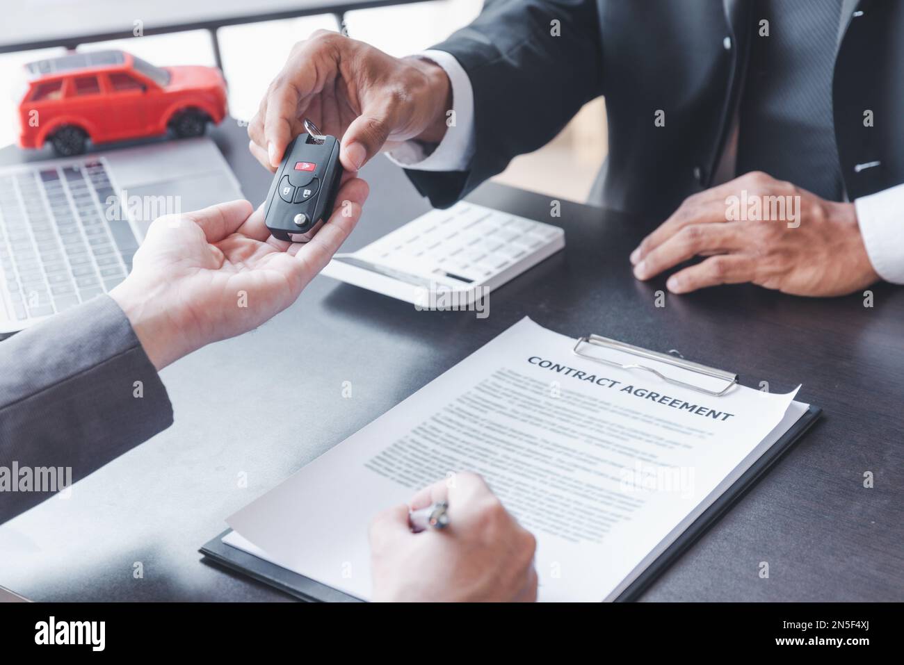 Concept of Car insurance or rental, salesman is making deal with buyer ...