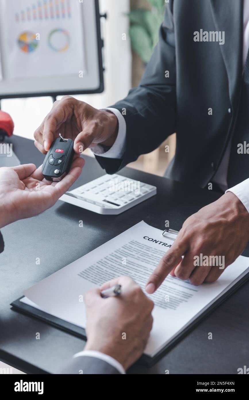 Concept of Car insurance or rental, salesman is making deal with buyer ...