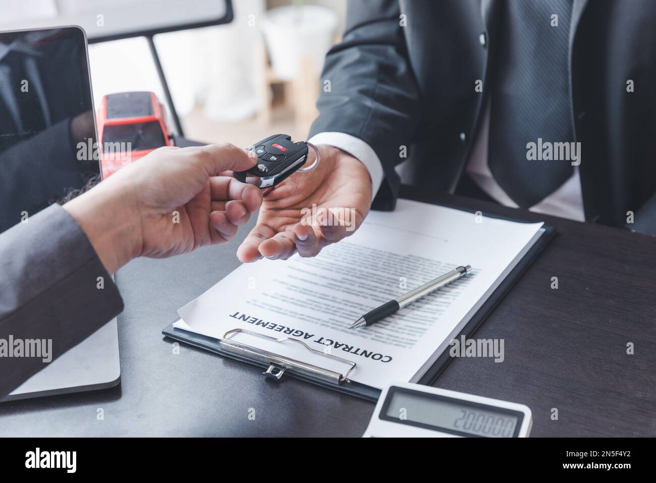 Concept of Car insurance or rental, salesman is making deal with buyer ...