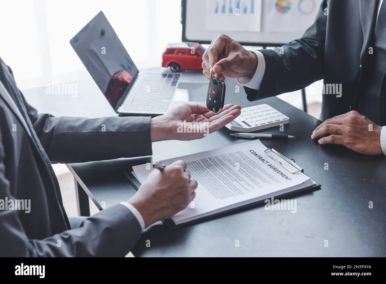 Concept of Car insurance or rental, salesman is making deal with buyer ...