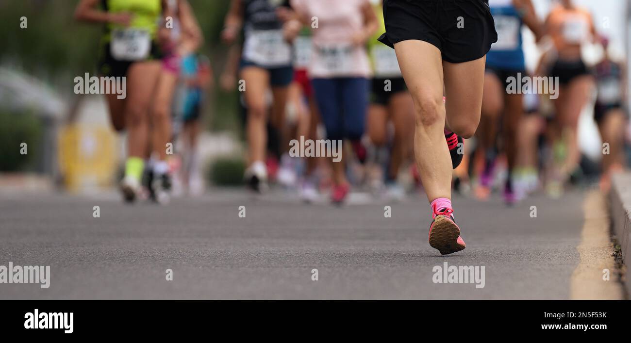 Marathon runners running on city road, large group of runners Stock ...