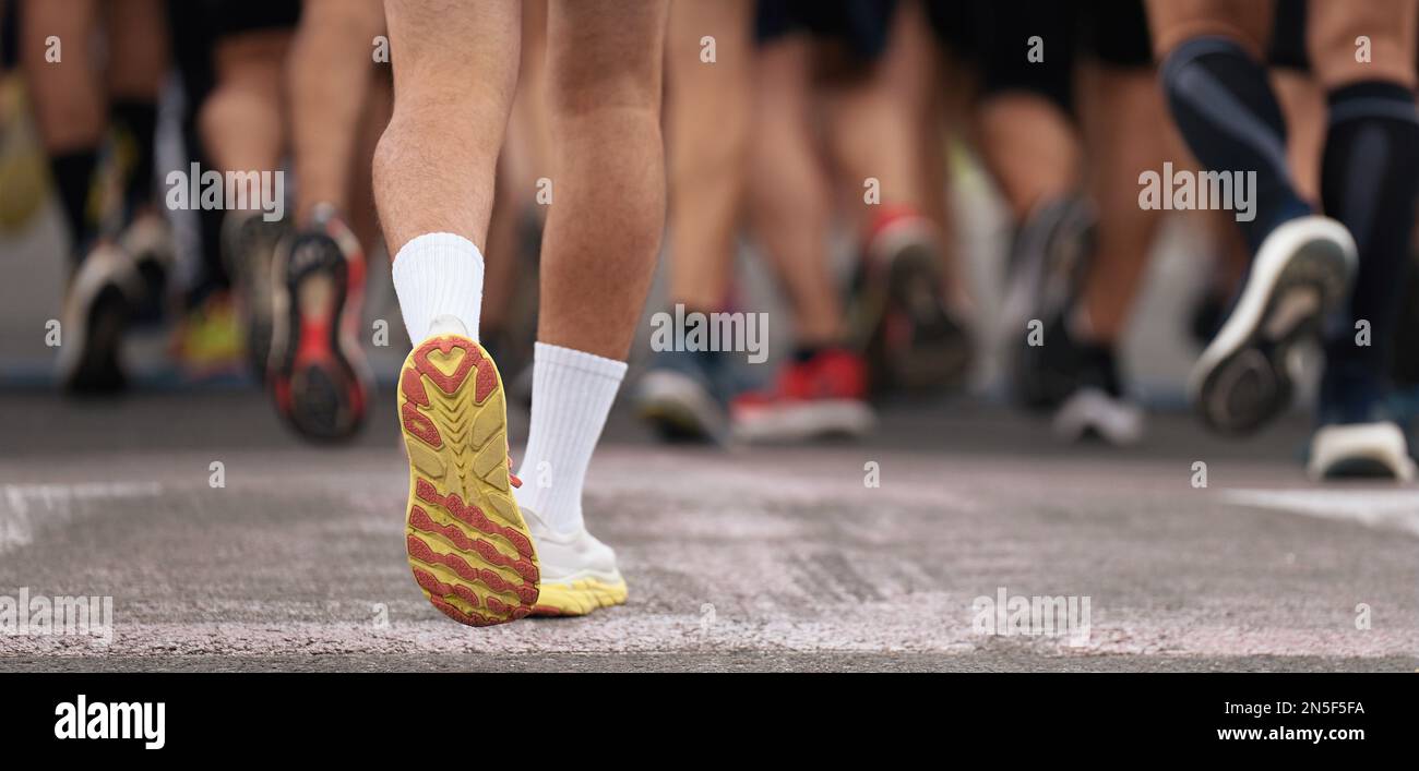Marathon runners running on city road, large group of runners Stock ...