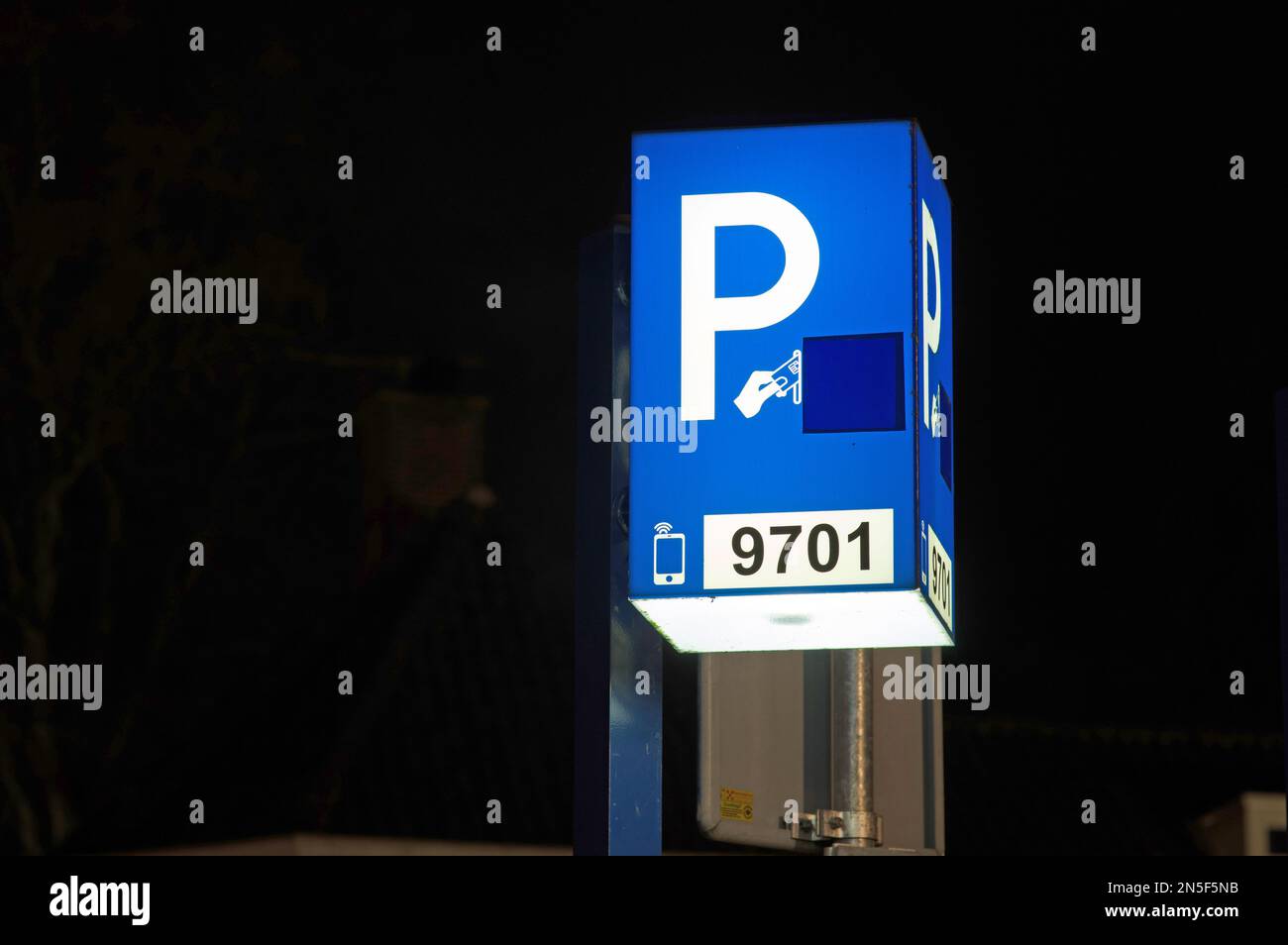 Blue and white illuminated parking sign at night Stock Photo - Alamy