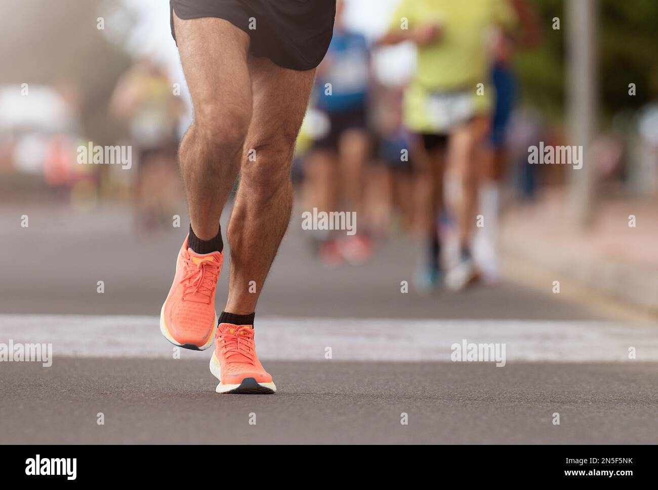 Marathon runners running on city road, large group of runners Stock ...