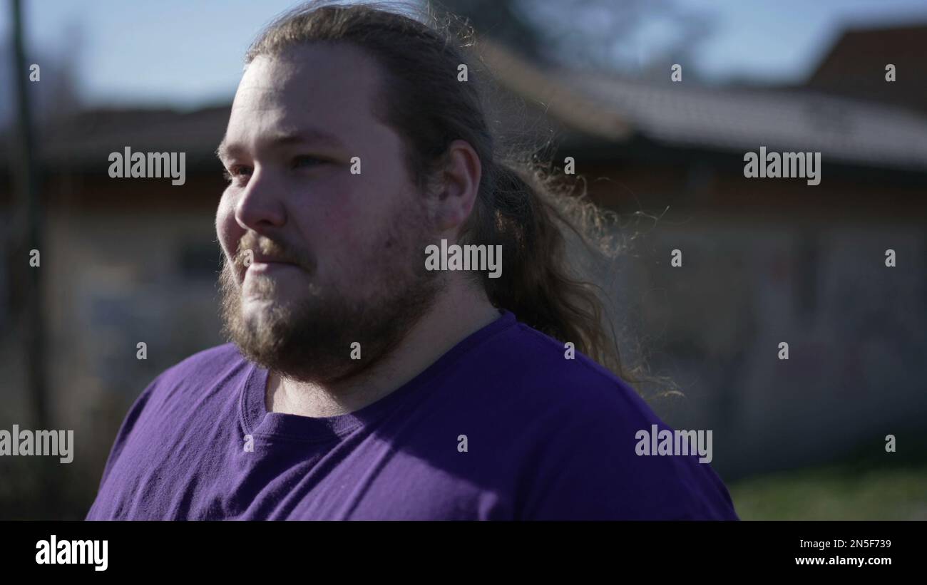 Positive overweight man walking outside exercising. A fat positive ...