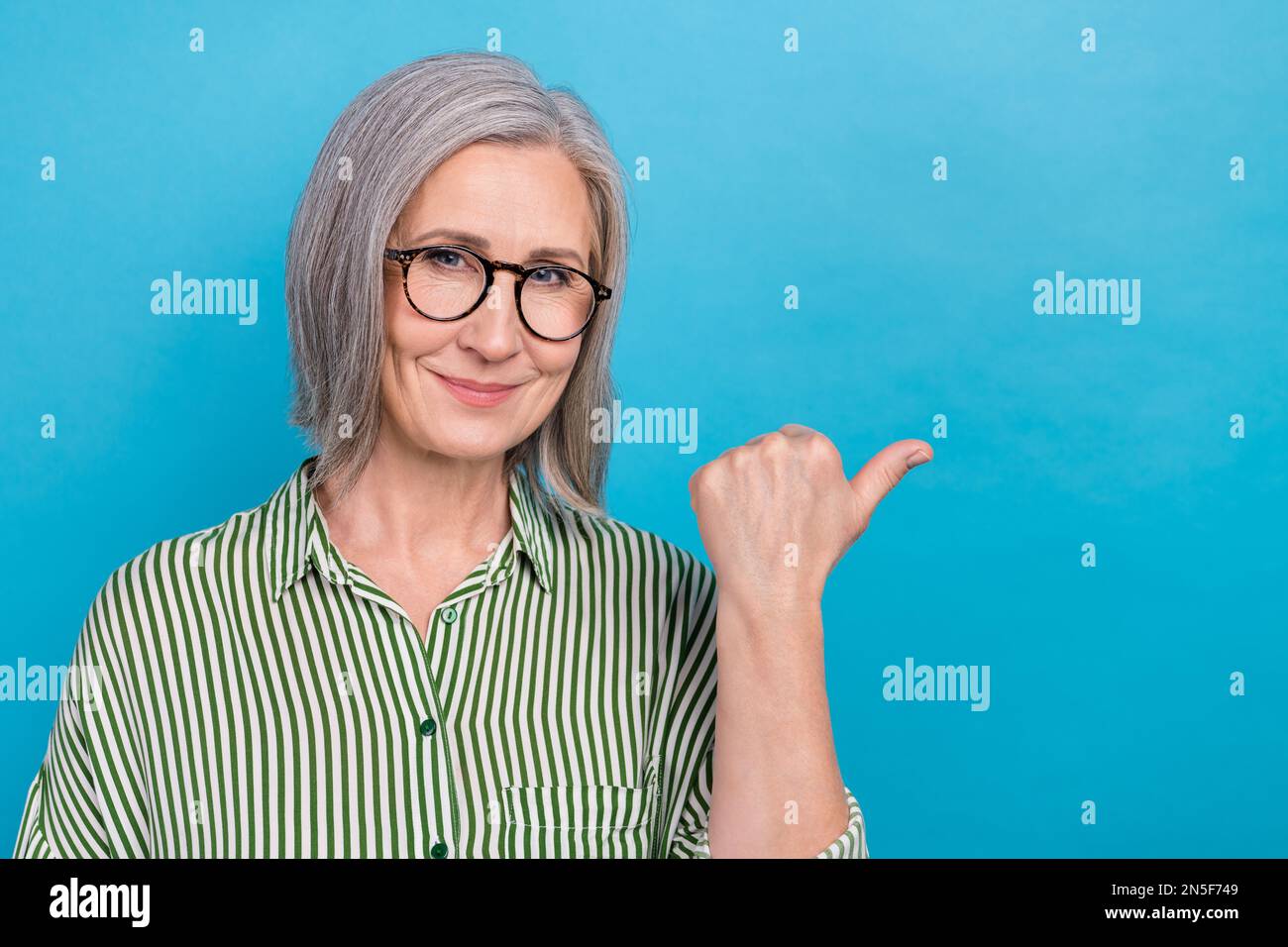 Portrait of positive pretty person direct finger empty space ...