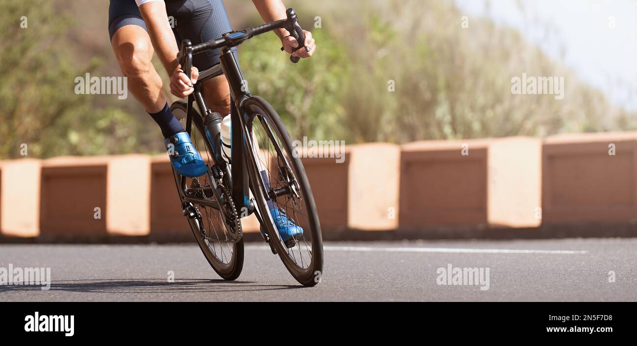 Road bike cyclist man cycling, athlete on a race bike. Leaning into a ...