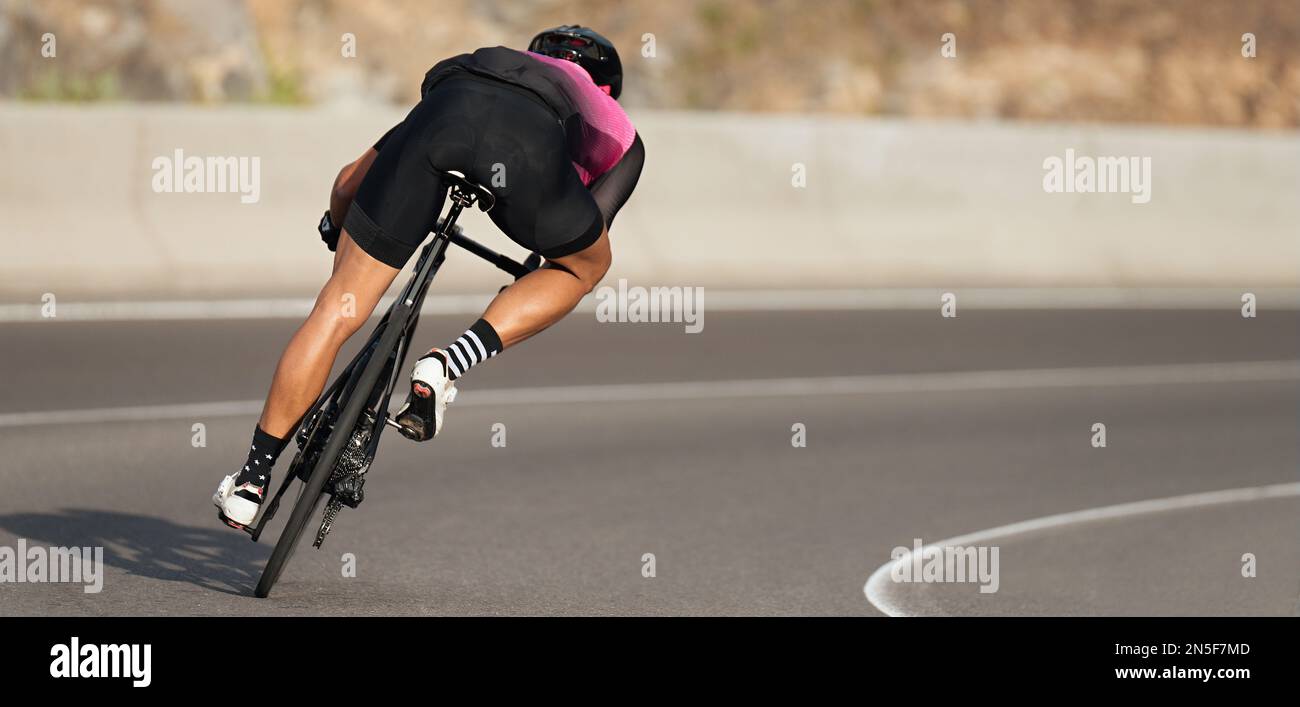 Road bike cyclist man cycling, athlete on a race bike. Leaning into a ...