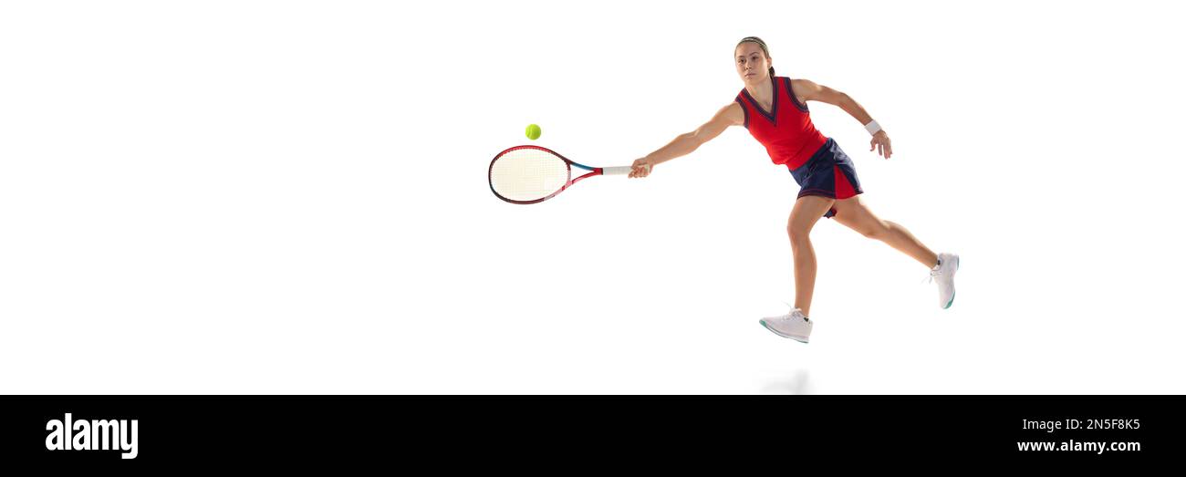 Studio shot of active teen girl, professional tennis player training ...