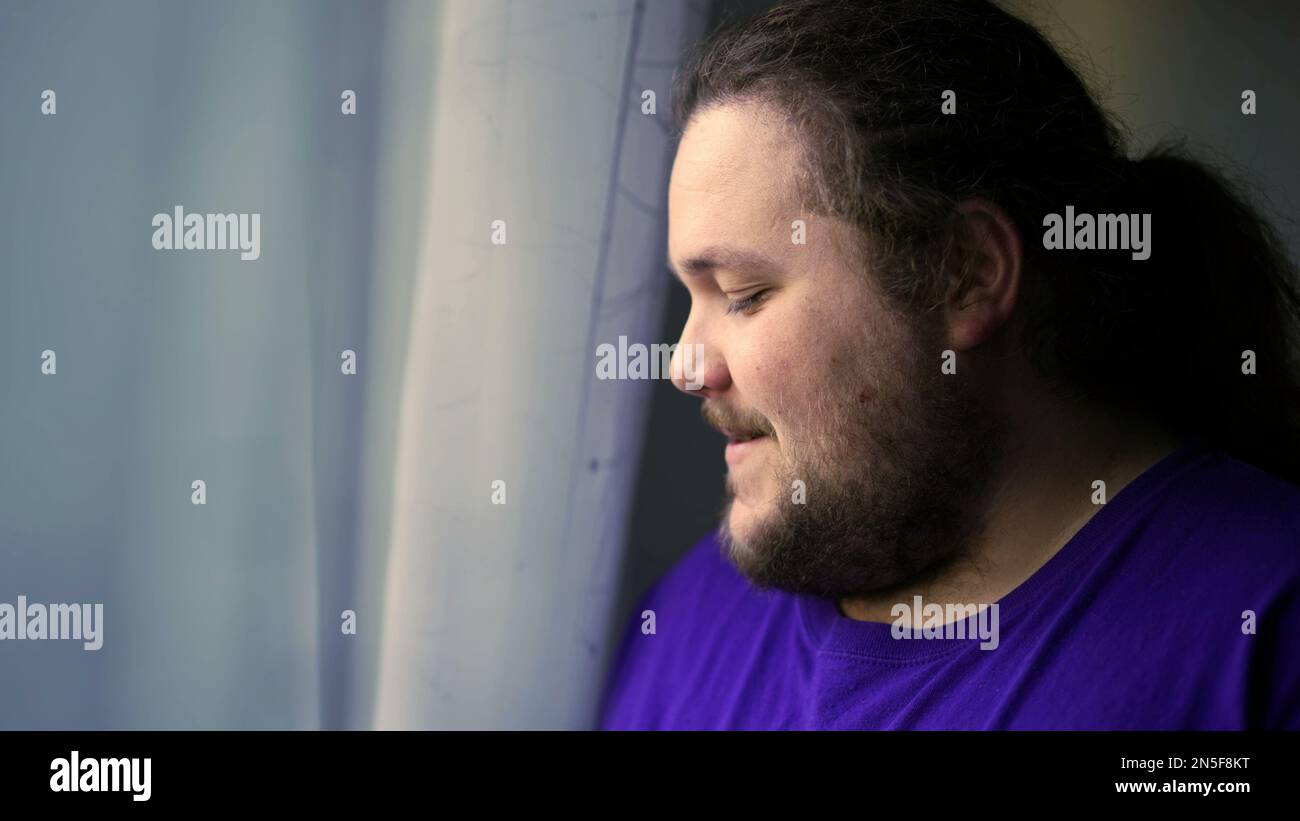 One happy casual chubby man smiling by home window looking out Stock ...