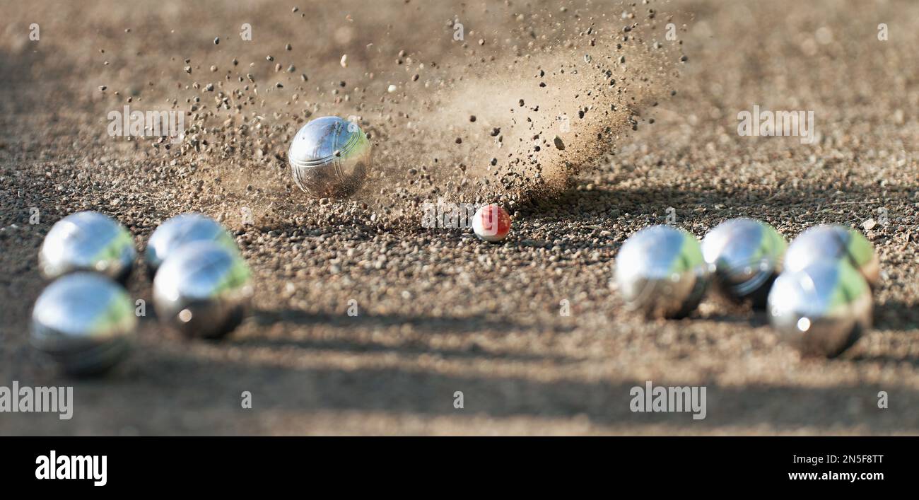 Petanque ball boules bowls on a dust floor, photo in impact. Game of ...