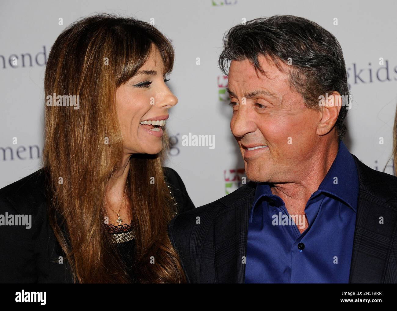 Sylvester Stallone, right, and his wife Jennifer Flavin share a laugh at the Mending Kids "Rock ...