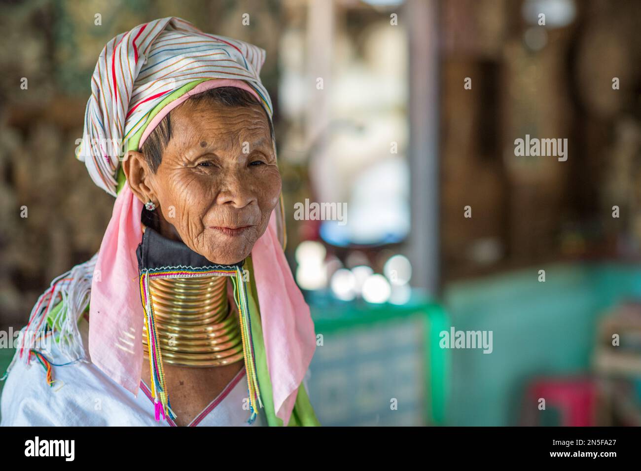 Portrait of a long neck Kayan woman in Bagan, Myanmar. Brass coils ...