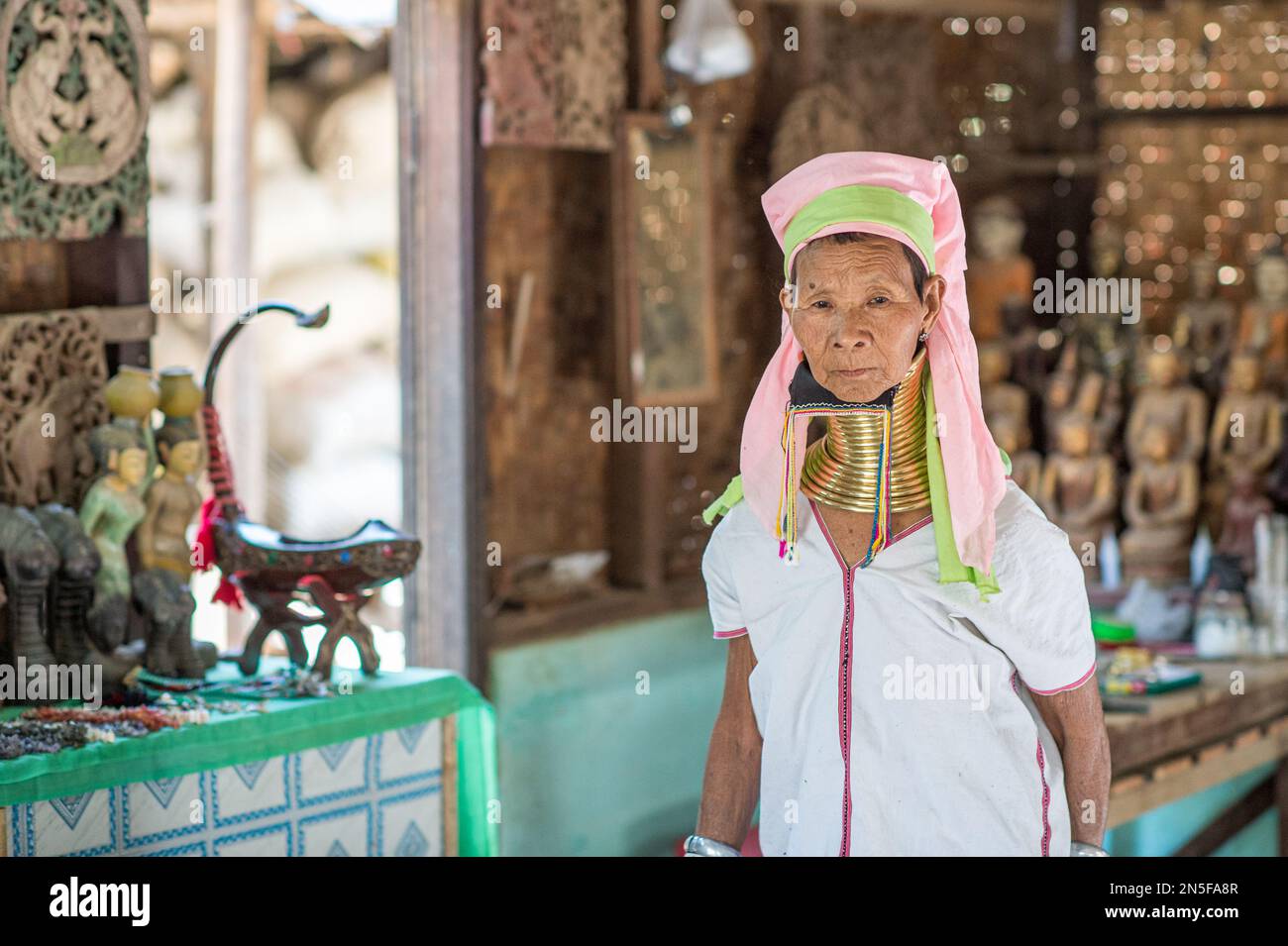 Portrait of a long neck Kayan woman in Bagan, Myanmar. Brass coils ...