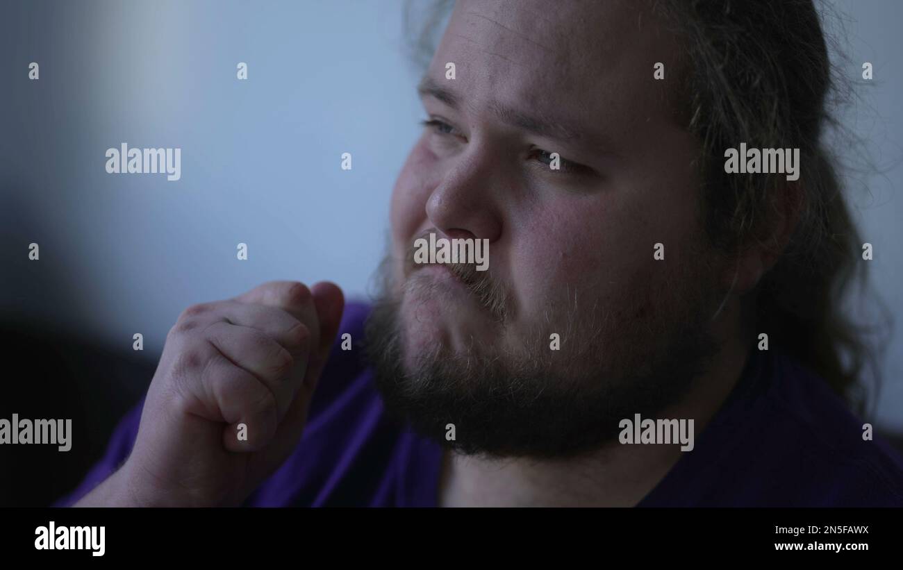 One worried overweight young man close up face feeling anxiety and ...