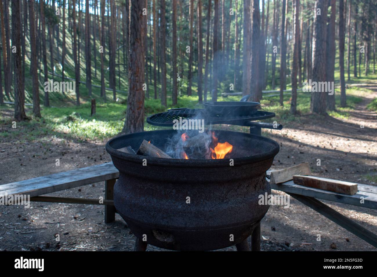 Bonfire lit on the shore of a lake. Big fire that warms the air ...