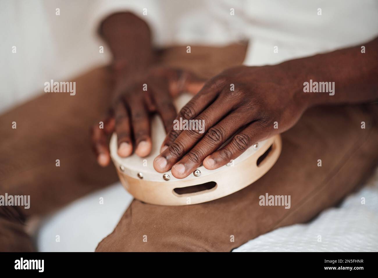 Candid authentic hands of african american man on tambourine being ...