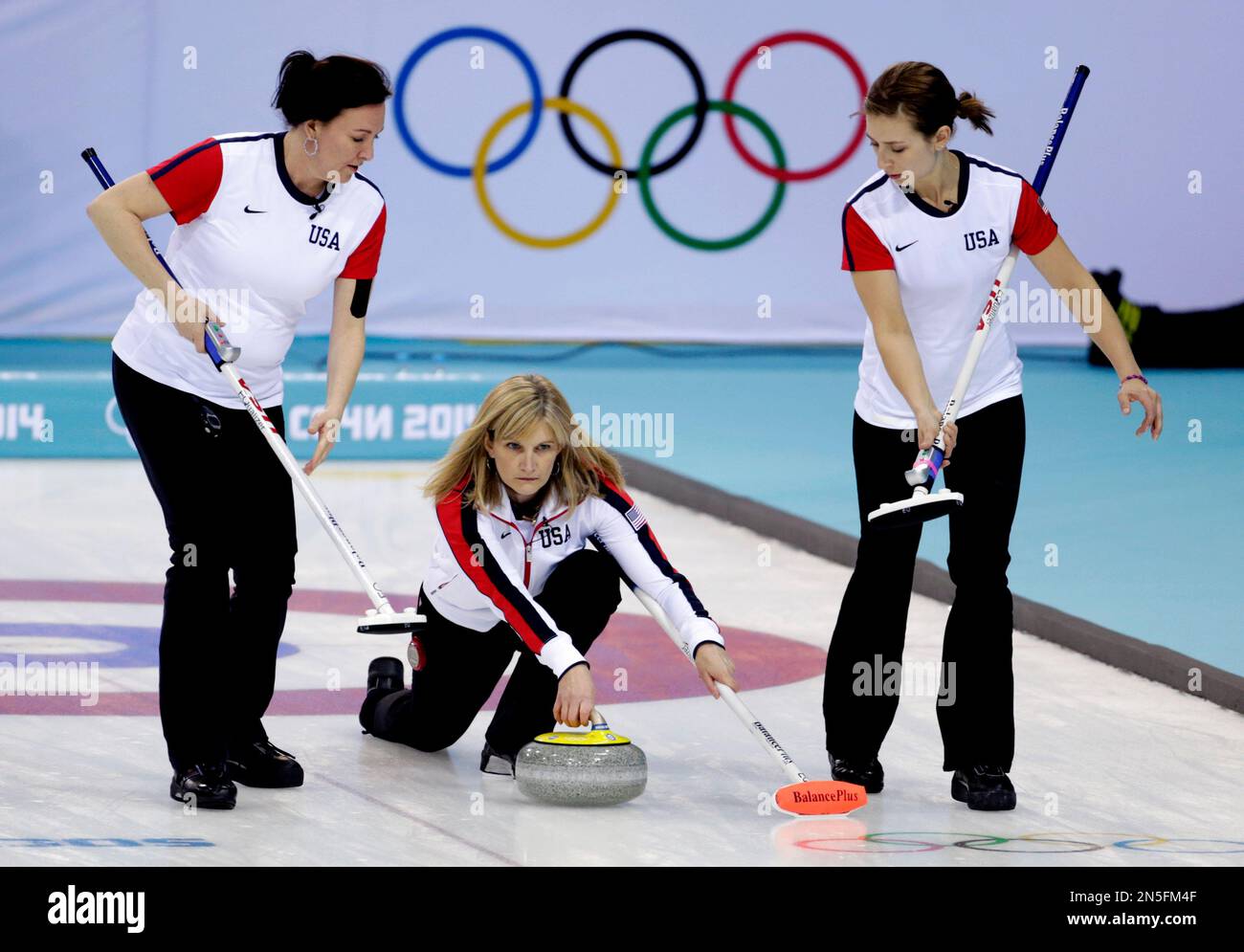 Erika Brown, skip of the United States team, center, delivers the rock ...