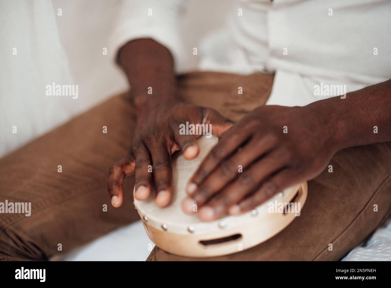 Candid authentic hands of african american man on tambourine being ...