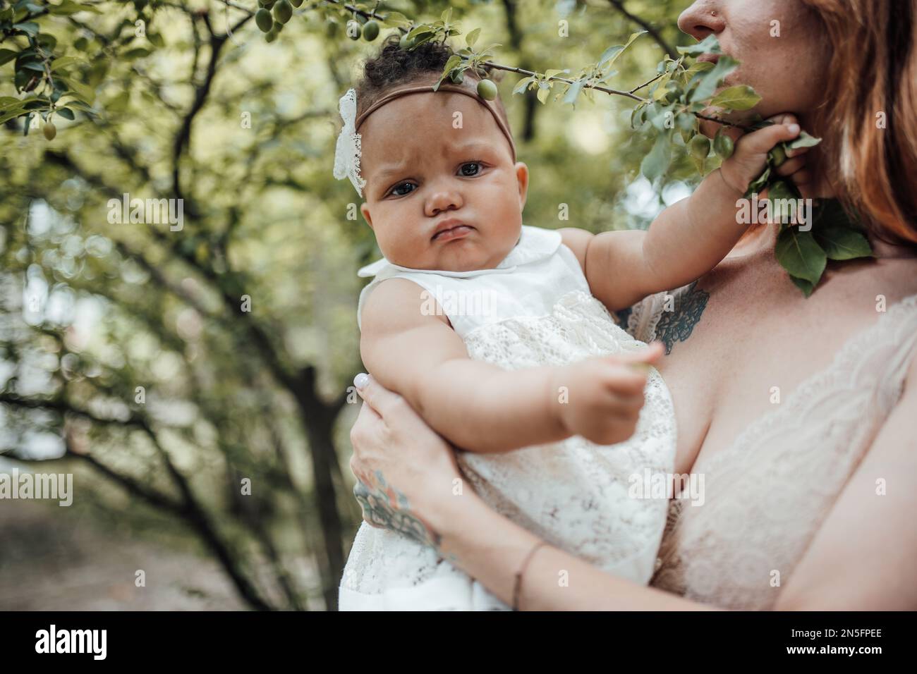 Diverse people portrait of mother with swarthy infant spending time in ...