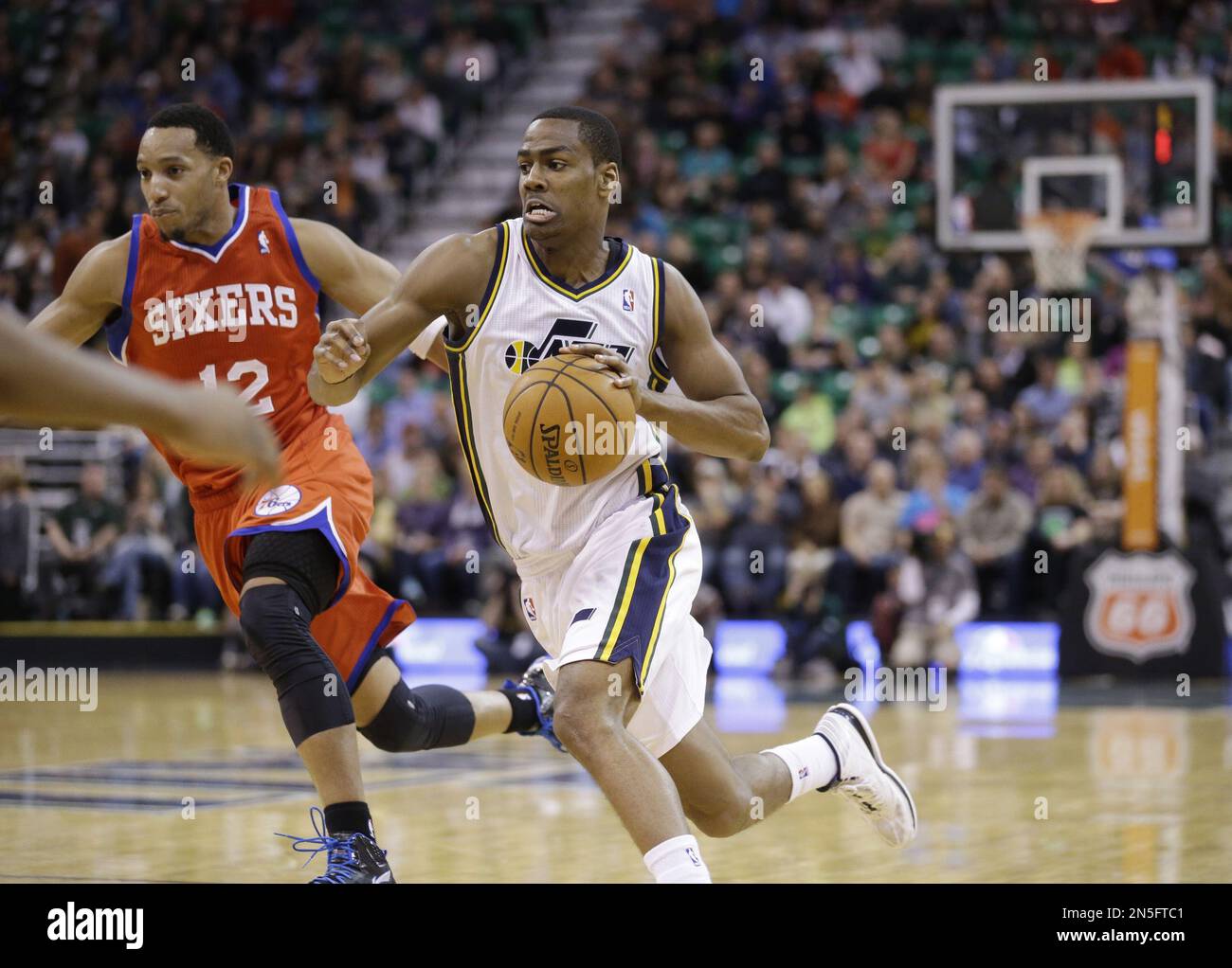 Utah Jazz's Alec Burks, right, drives around Philadelphia 76ers' Evan ...