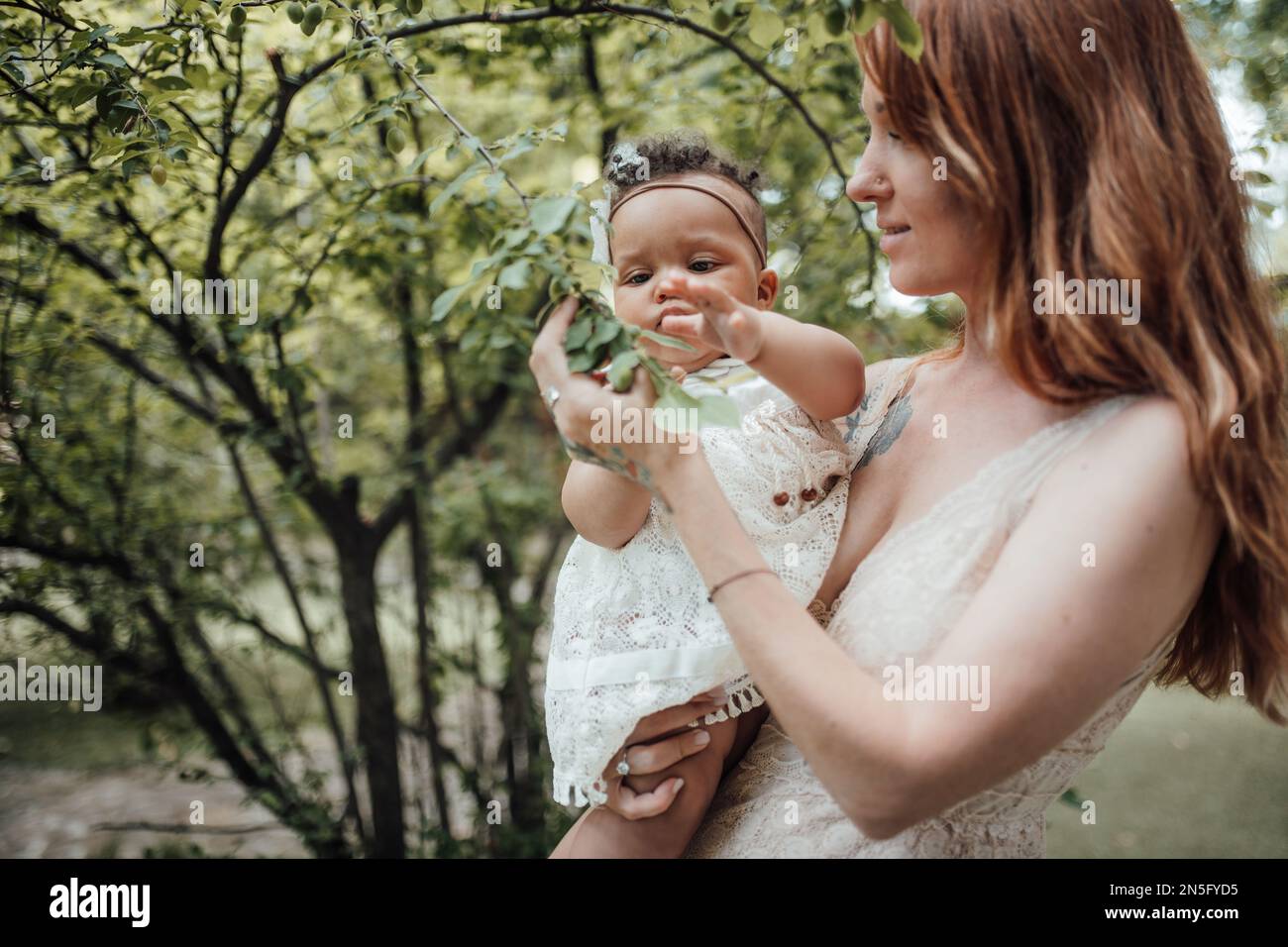 Diverse people portrait of mother with swarthy infant spending time in ...