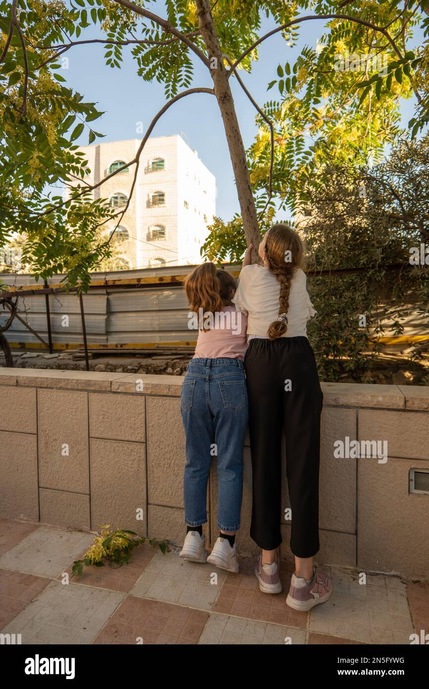 Bethlehem, West Bank, Palestine - 22 July 2022: Two Young Girls Try to ...
