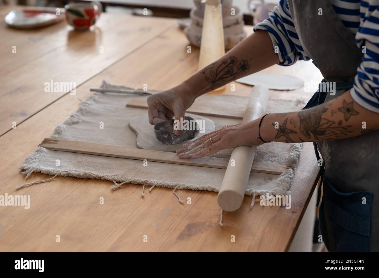 Close-up of creative female artist's hand creating raw clay masterpiece ...