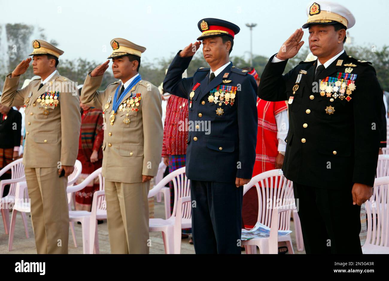 Myanmar government officials salute Myanmar National Flag during a ...