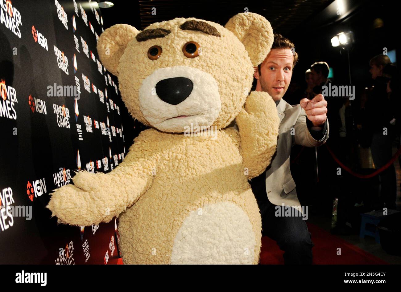 Ben Begley, a cast member in "The Hungover Games," poses with fellow cast member "Teddy" at the ...
