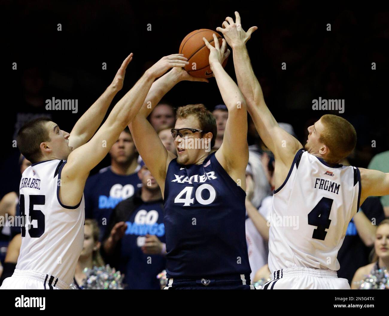Xavier center Matt Stainbrook (40) is trapped by Butler forwards Andrew ...