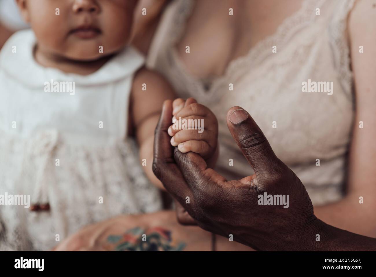 Mixed race family with white son and infant swarthy daughter spend time ...