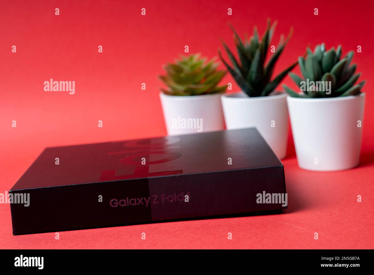 Brand new Samsung Galaxy Z Fold 4 in original box. Against a red ...