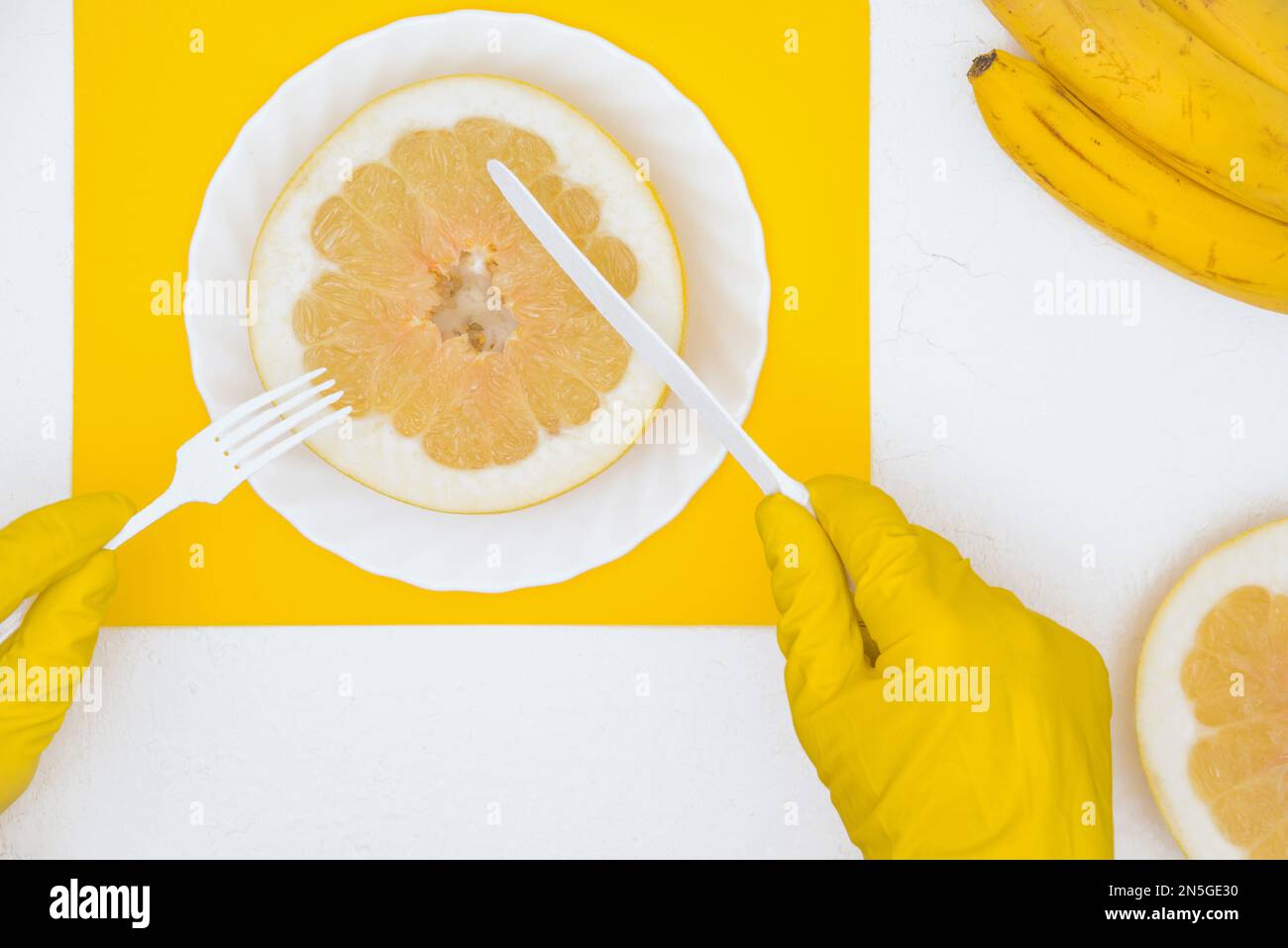 Human eats his lunch. Man in rubber gloves holds knife and fork, cuts ...
