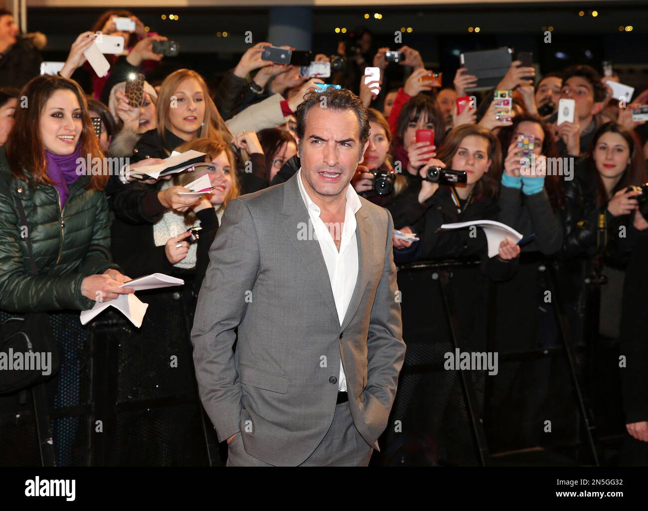 French actor Jean Dujardin poses for photographers on the red carpet ...