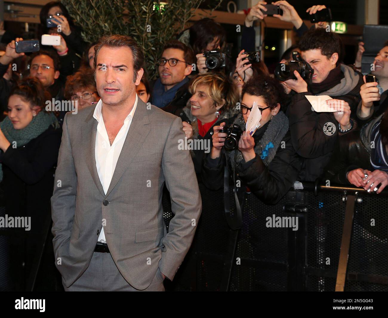 French actor Jean Dujardin poses for photographers on the red carpet ...