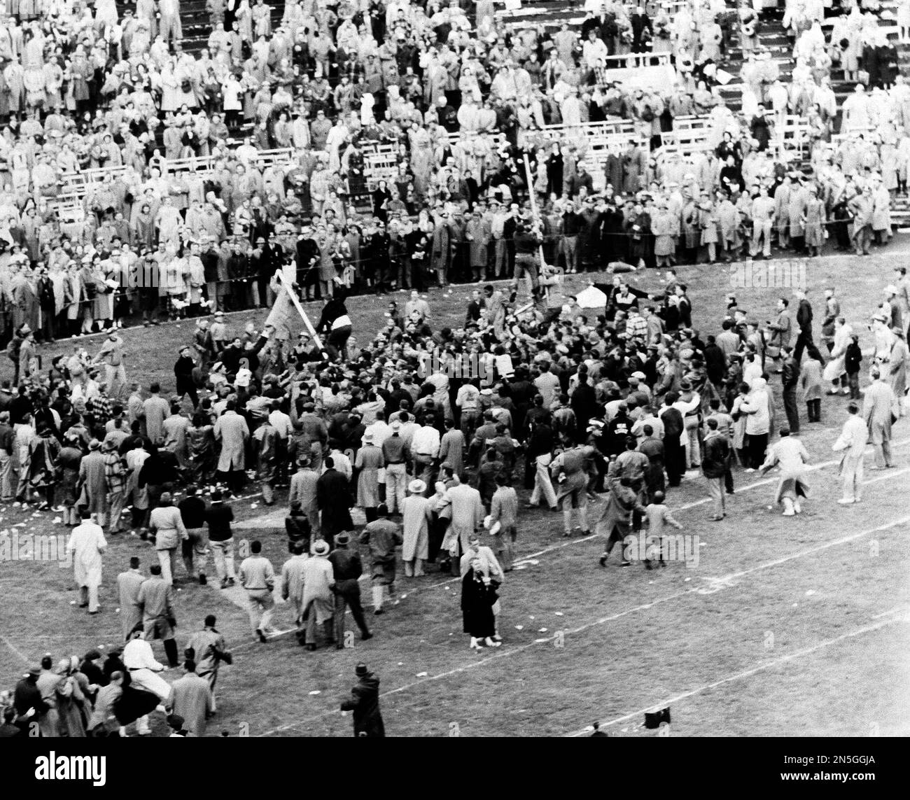 The goal posts are town down in the Ohio Stadium as a big crowd of ...