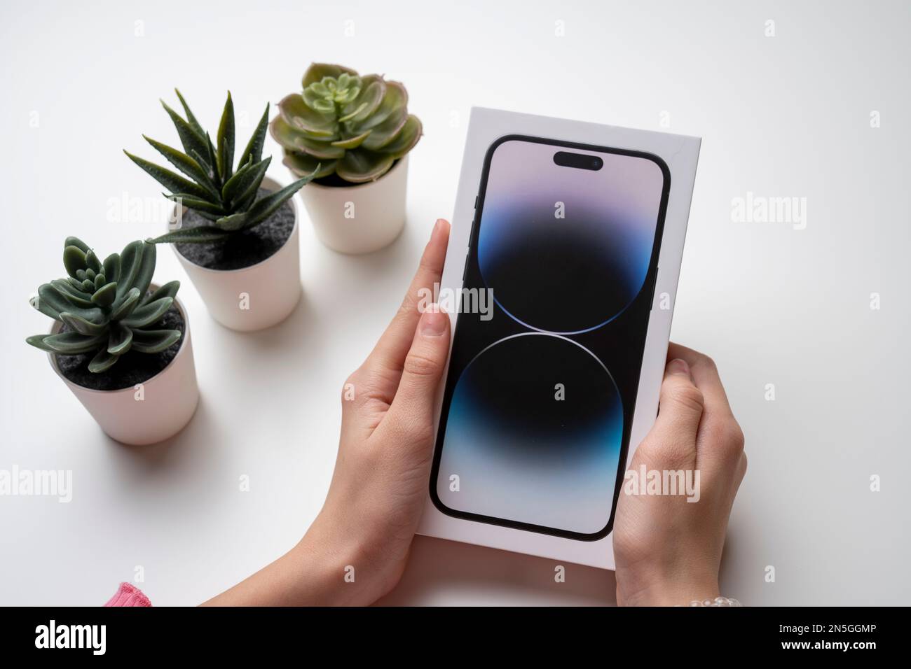 A girl holds the latest iPhone 14 Pro Max, Space Black. Apple's latest ...