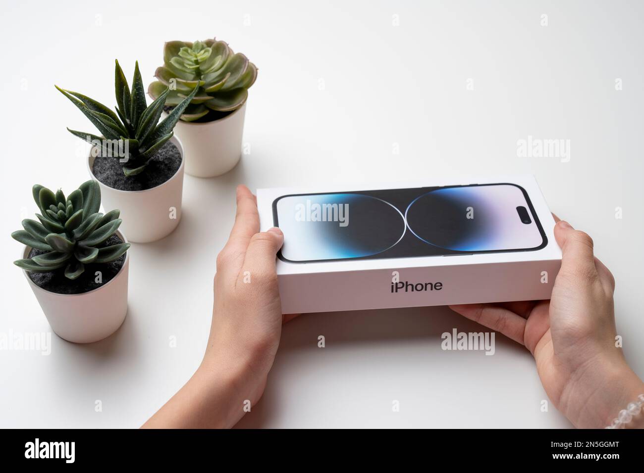 A girl holds the latest iPhone 14 Pro Max, Space Black. Apple's latest ...