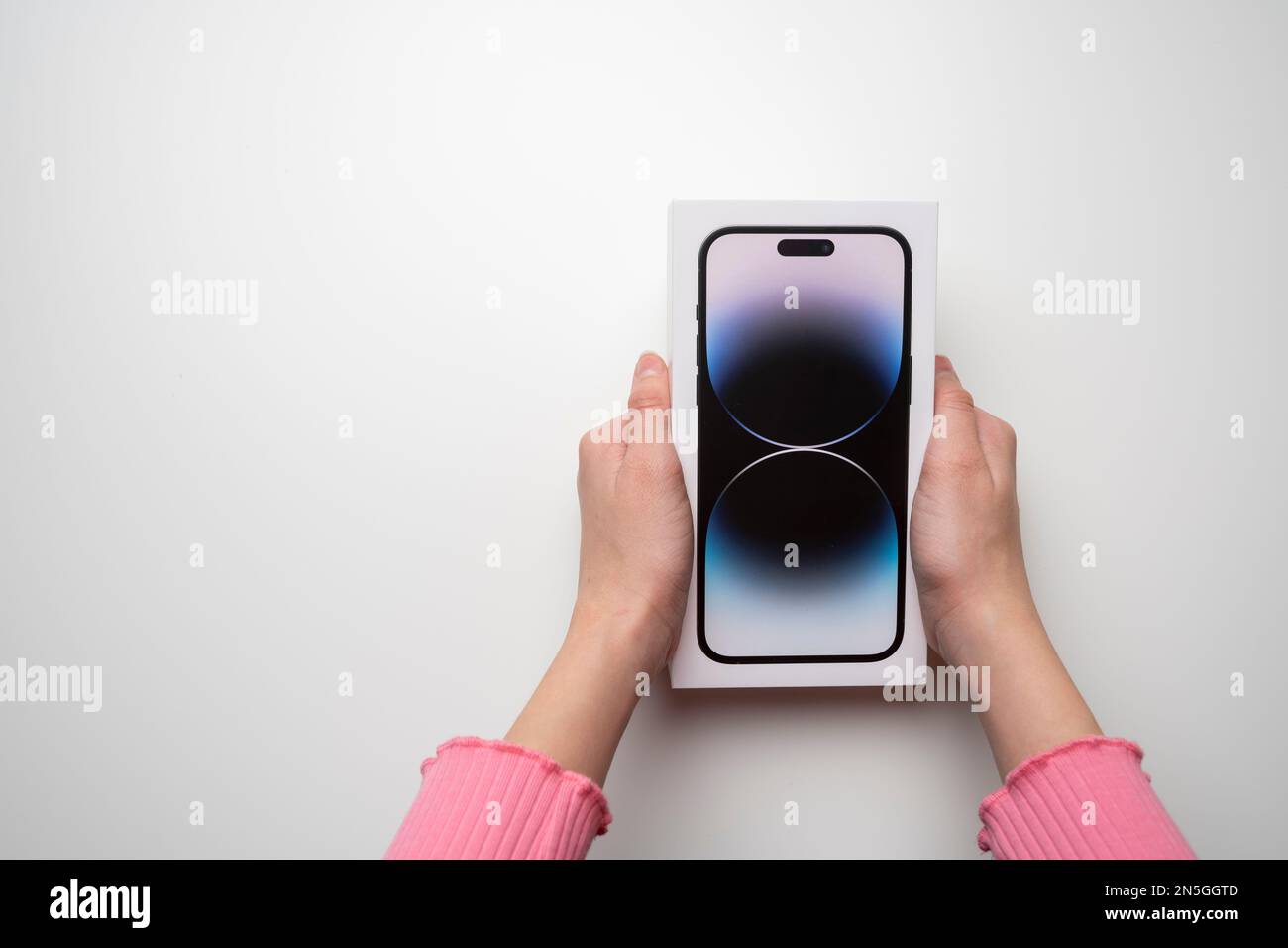 A girl holds the latest iPhone 14 Pro Max, Space Black. Apple's latest ...