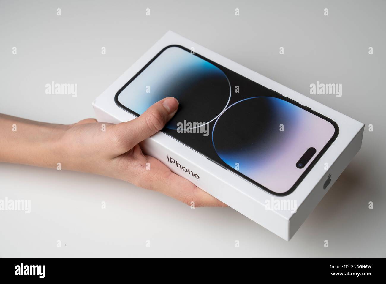 A girl holds the latest iPhone 14 Pro Max, Space Black. Apple's latest ...